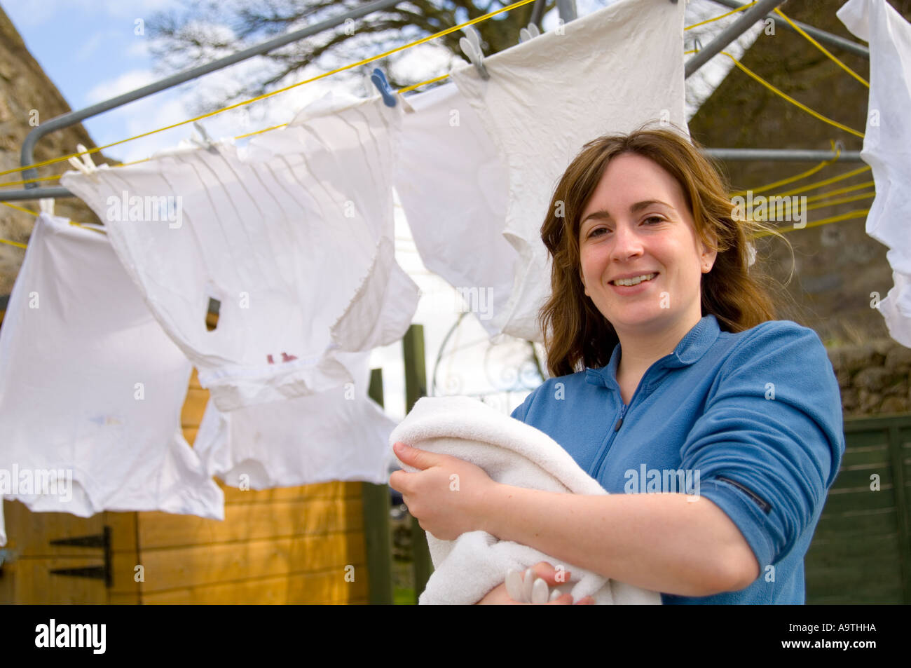 young woman hanging out laundry Stock Photo - Alamy