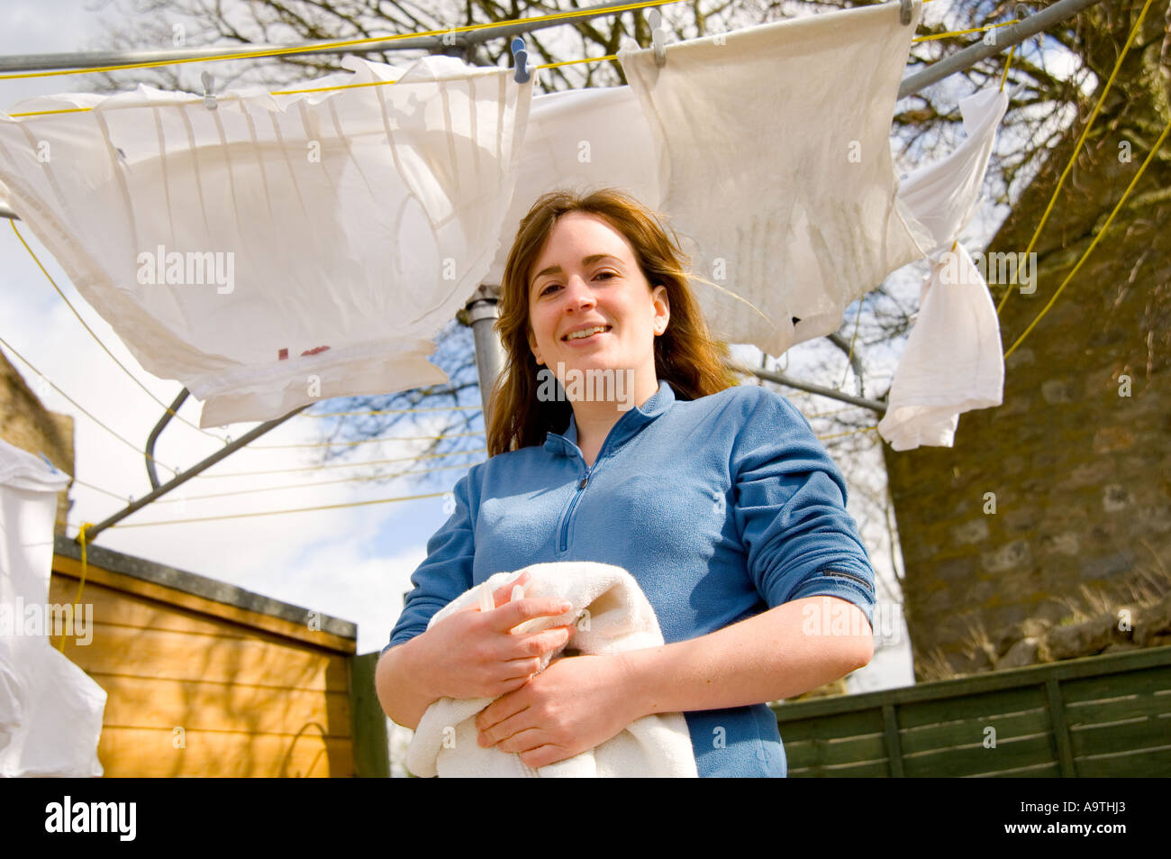 young woman hanging out laundry Stock Photo - Alamy