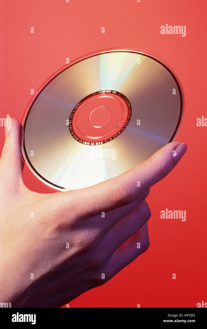 WOMAN'S HAND HOLDING CD ROM Stock Photo - Alamy