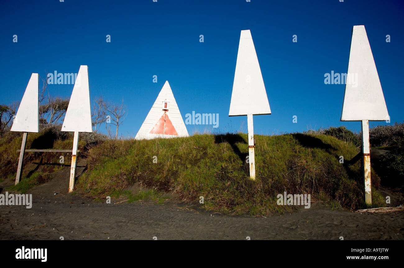 white wood triangles on the beach used for coastal navigation in raglan ...