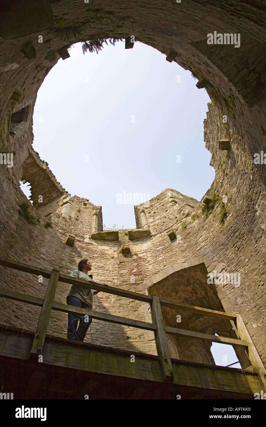 Female visitor inside the ruined tower of Bronllys Castle dating from ...