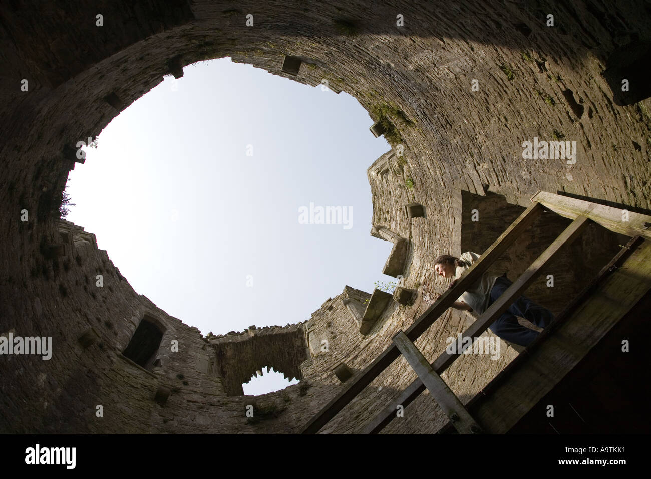 Female visitor in the ruined tower of Bronllys Castle dating from 13th ...