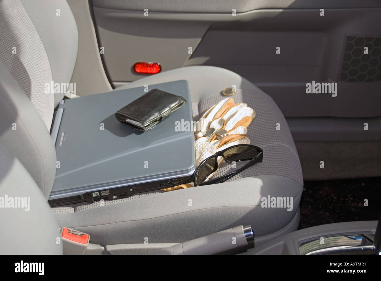 Valuables left on display on car seat Stock Photo - Alamy