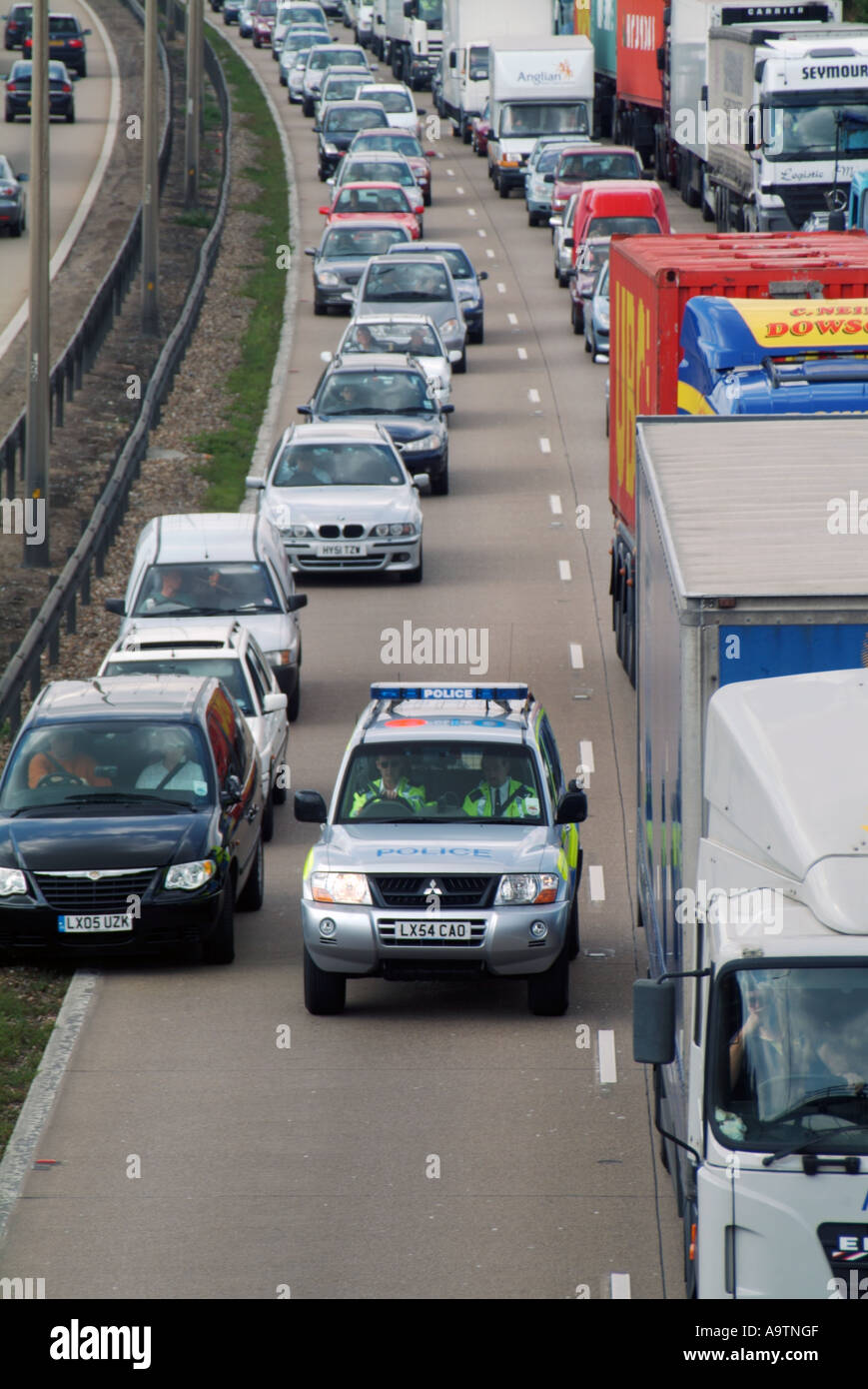 M25 motorway queuing traffic police car on emergency call trying to ...
