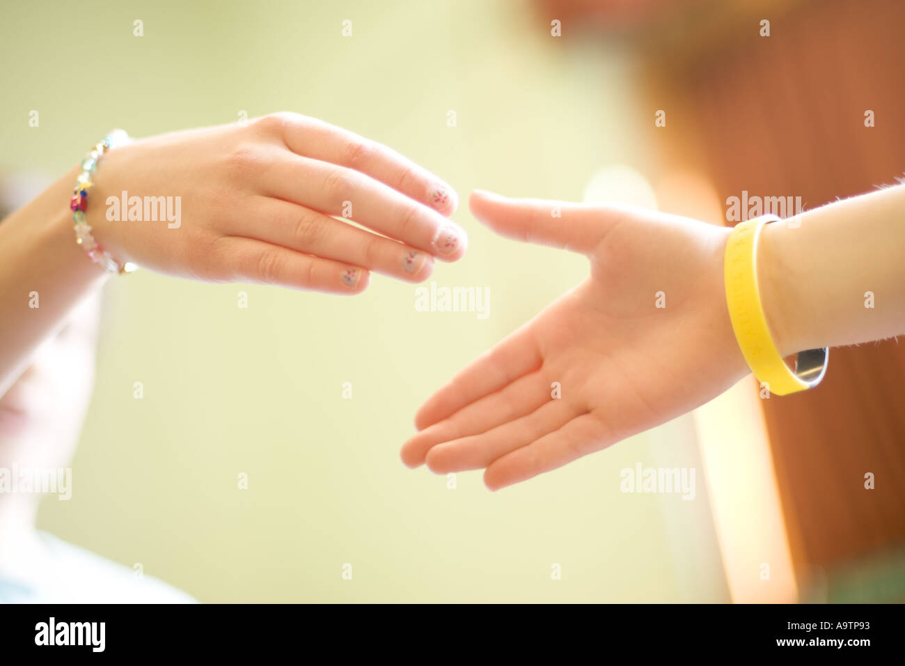 Two girls playing hand clapping game at school Stock Photo - Alamy