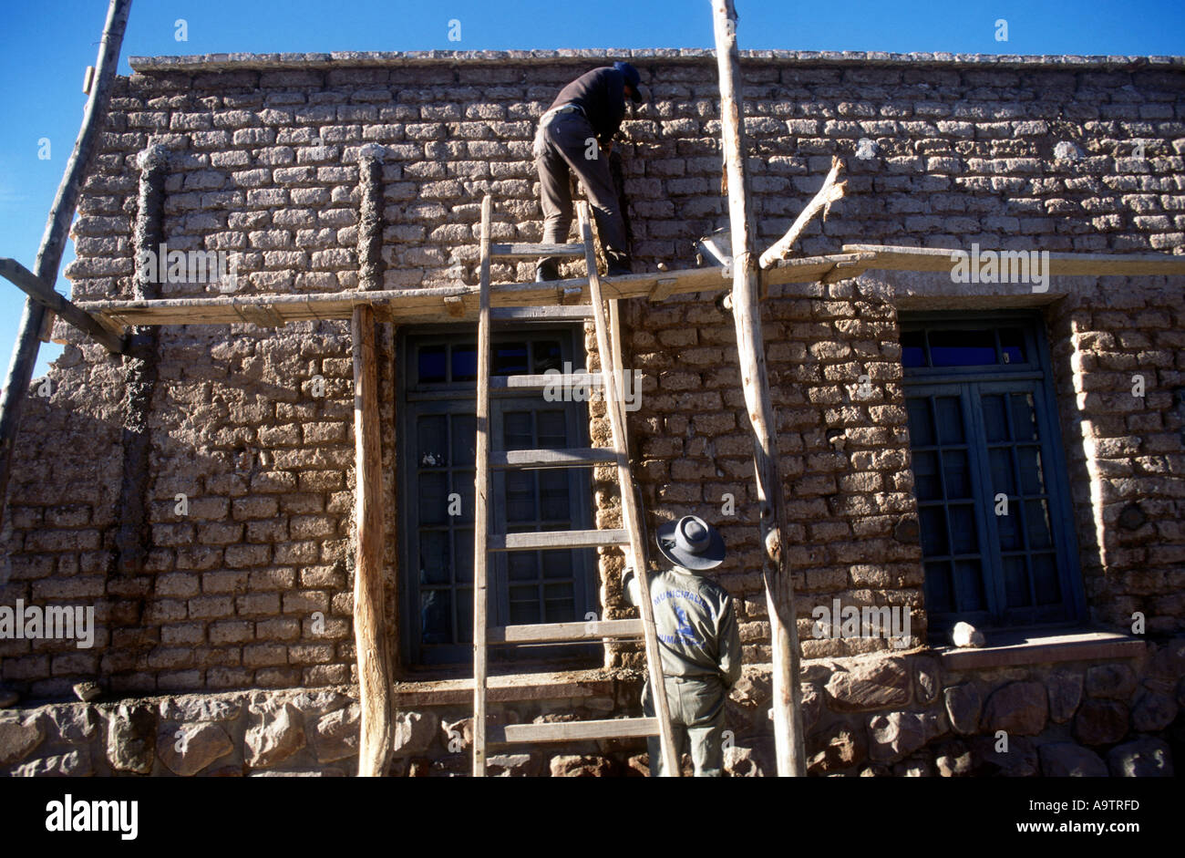 Men building a house with adobe or mud bricks Stock Photo - Alamy