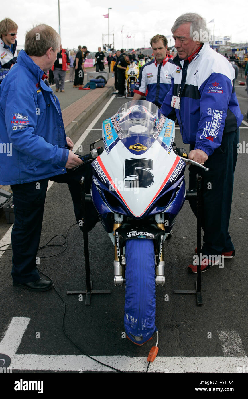 Adrian Archibalds TAS Suzuki bike and pit crew on the grid at the North ...