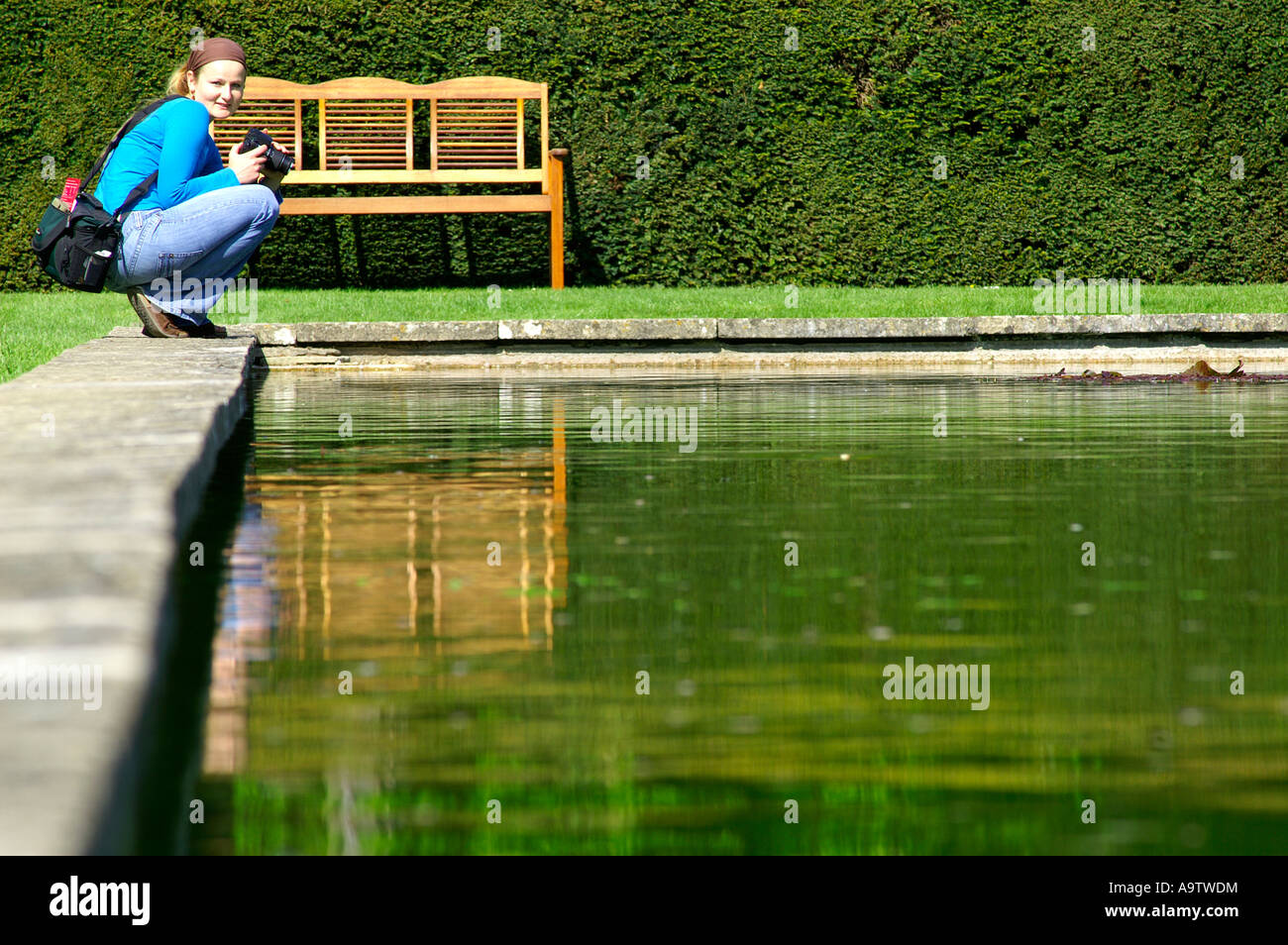woman crouching in the corner of swimming pool Stock Photo - Alamy