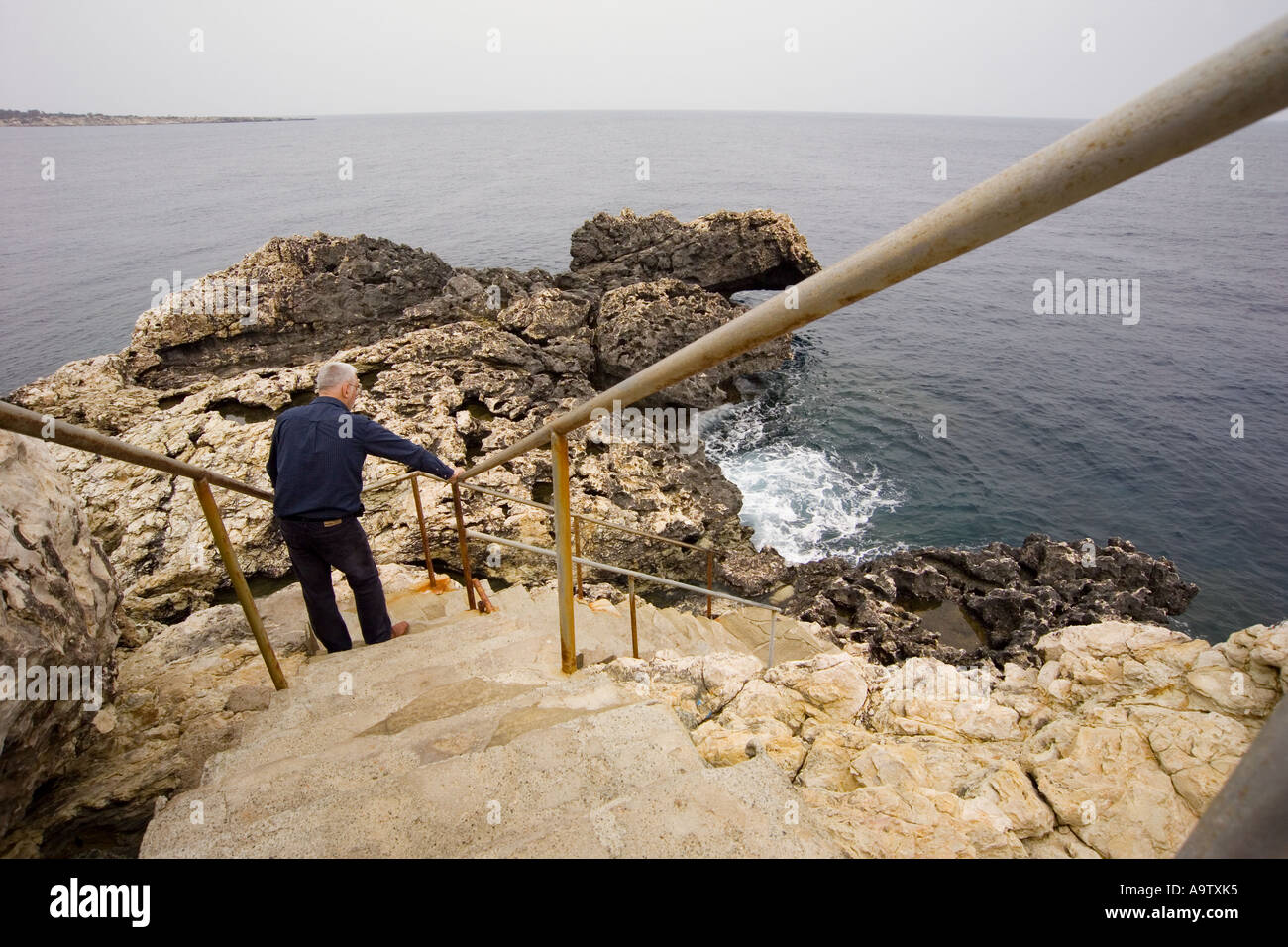 man on dangerous steps at Ayia Napa caves Stock Photo - Alamy