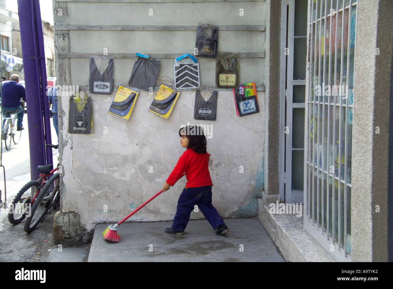 Little girl sweeping steps Stock Photo - Alamy