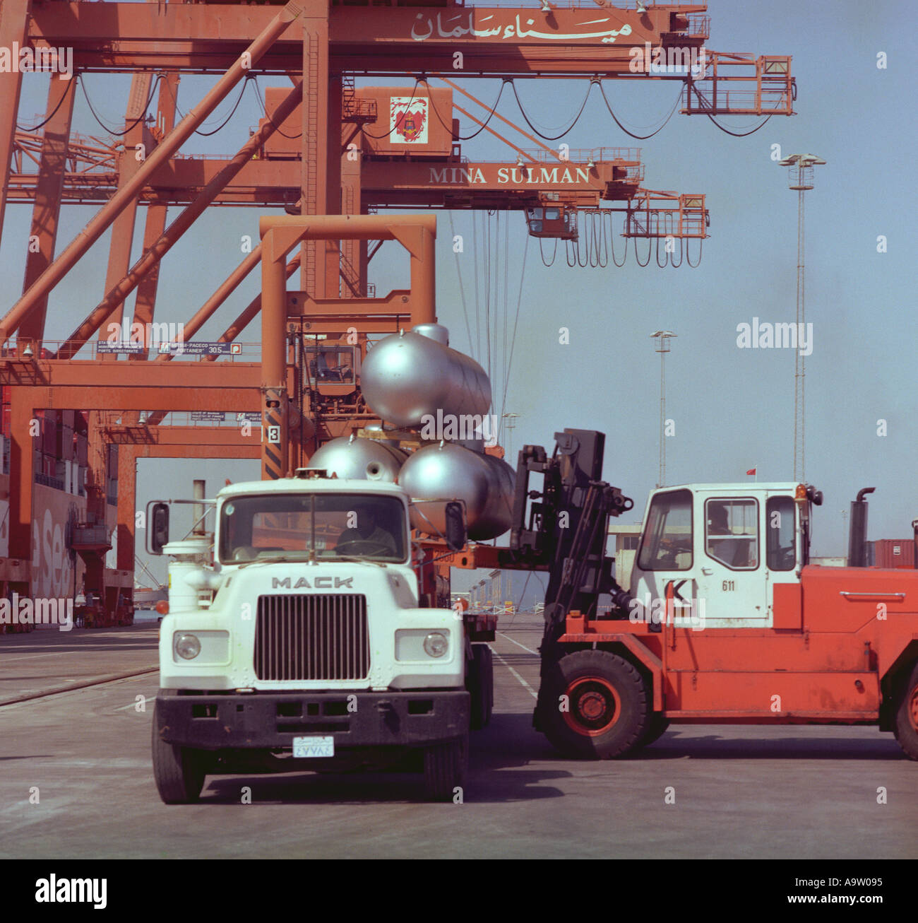 Dockside cargo being unloaded to truck by fork lift Mina Sulman Manama ...