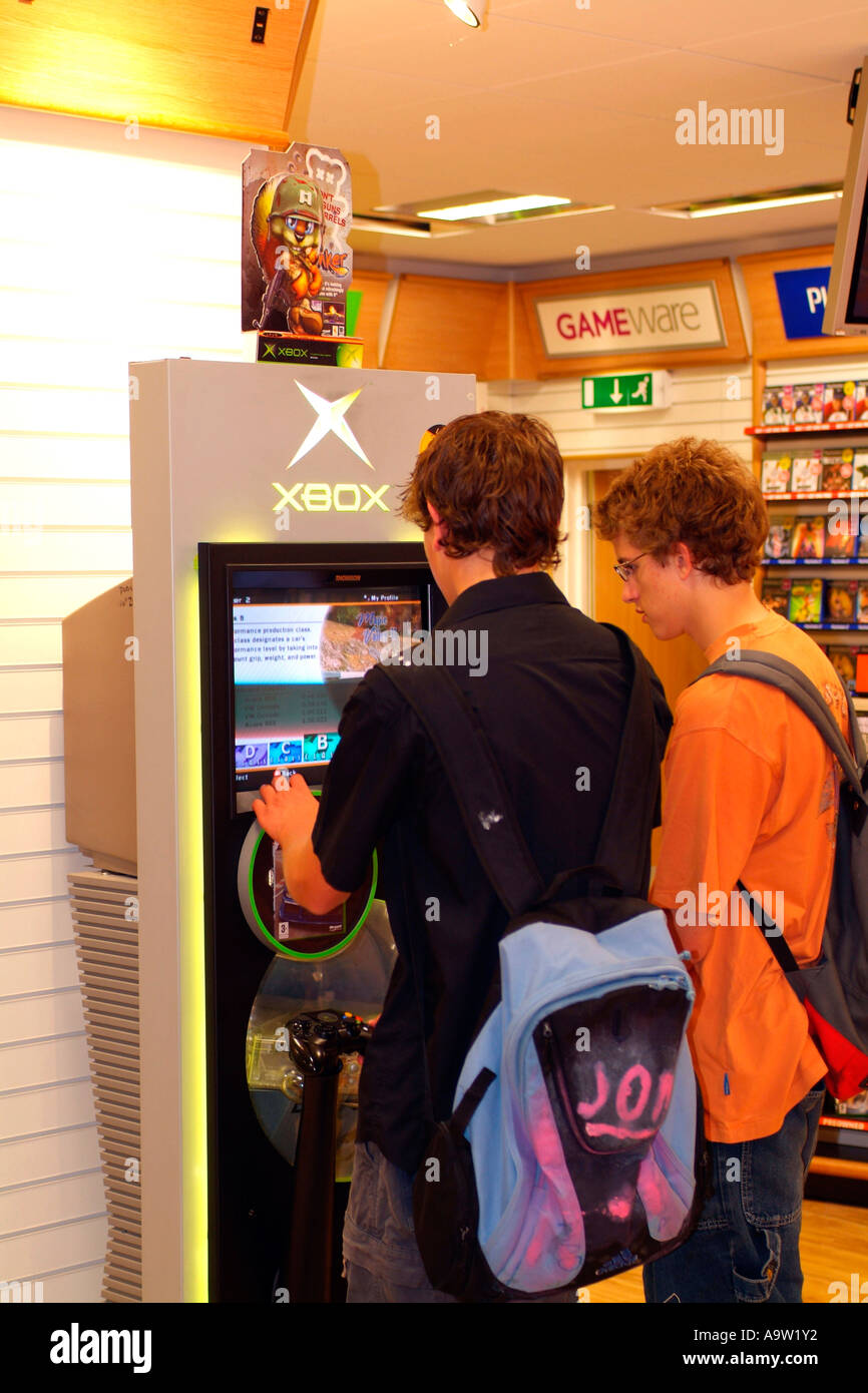 Teenage males playing Video arcade games on an X-box system Stock Photo ...