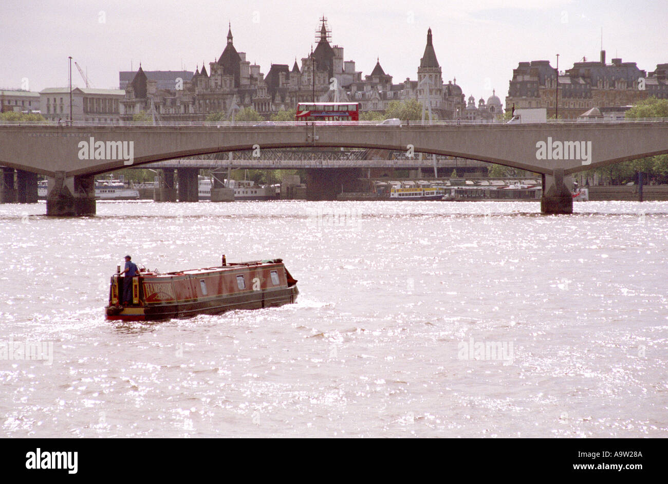 canal boat on river Thames approaching bridge London England Stock ...