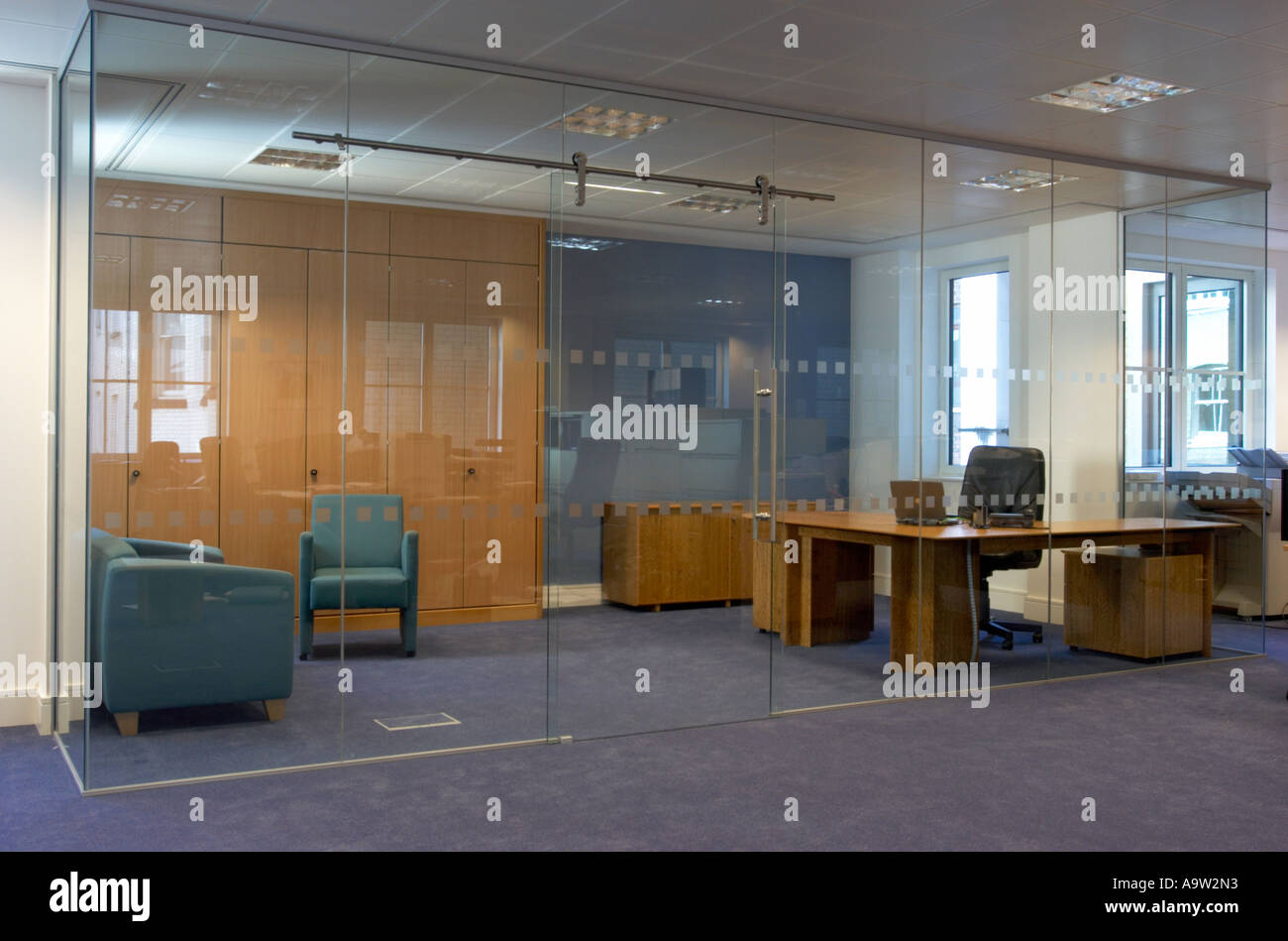 Directors office through glass partition Stock Photo - Alamy