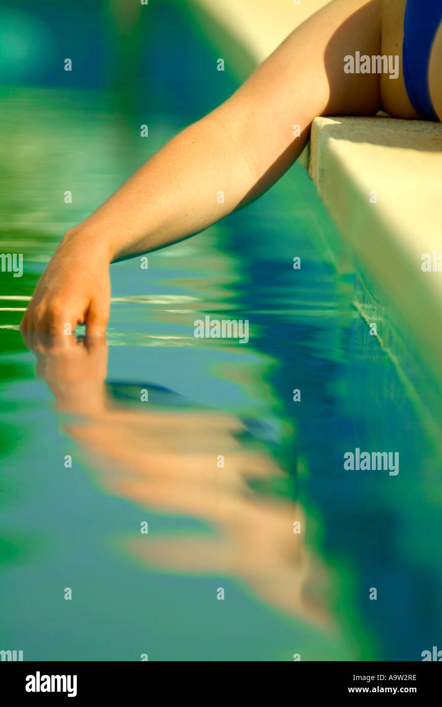 woman lying by outdoor swimming pool Stock Photo - Alamy