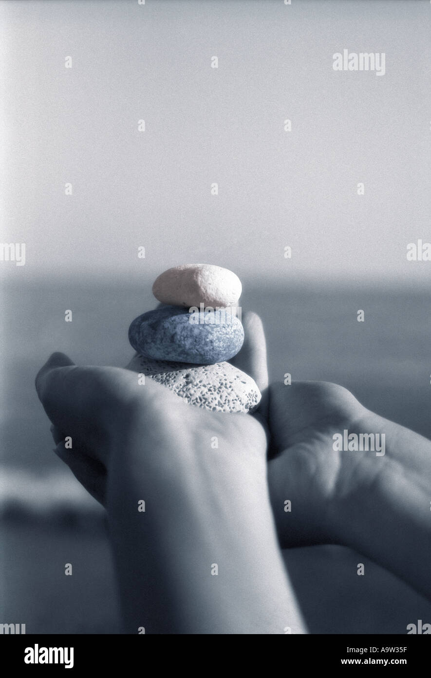 hands holding healing stones Stock Photo - Alamy