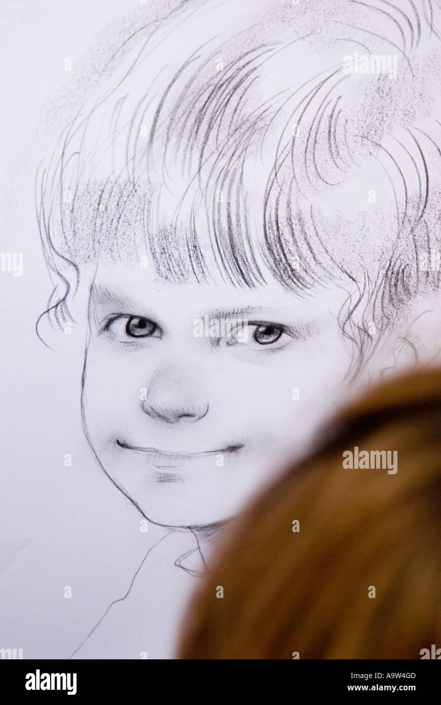 Artist drawing pencil portrait of a child Stock Photo - Alamy