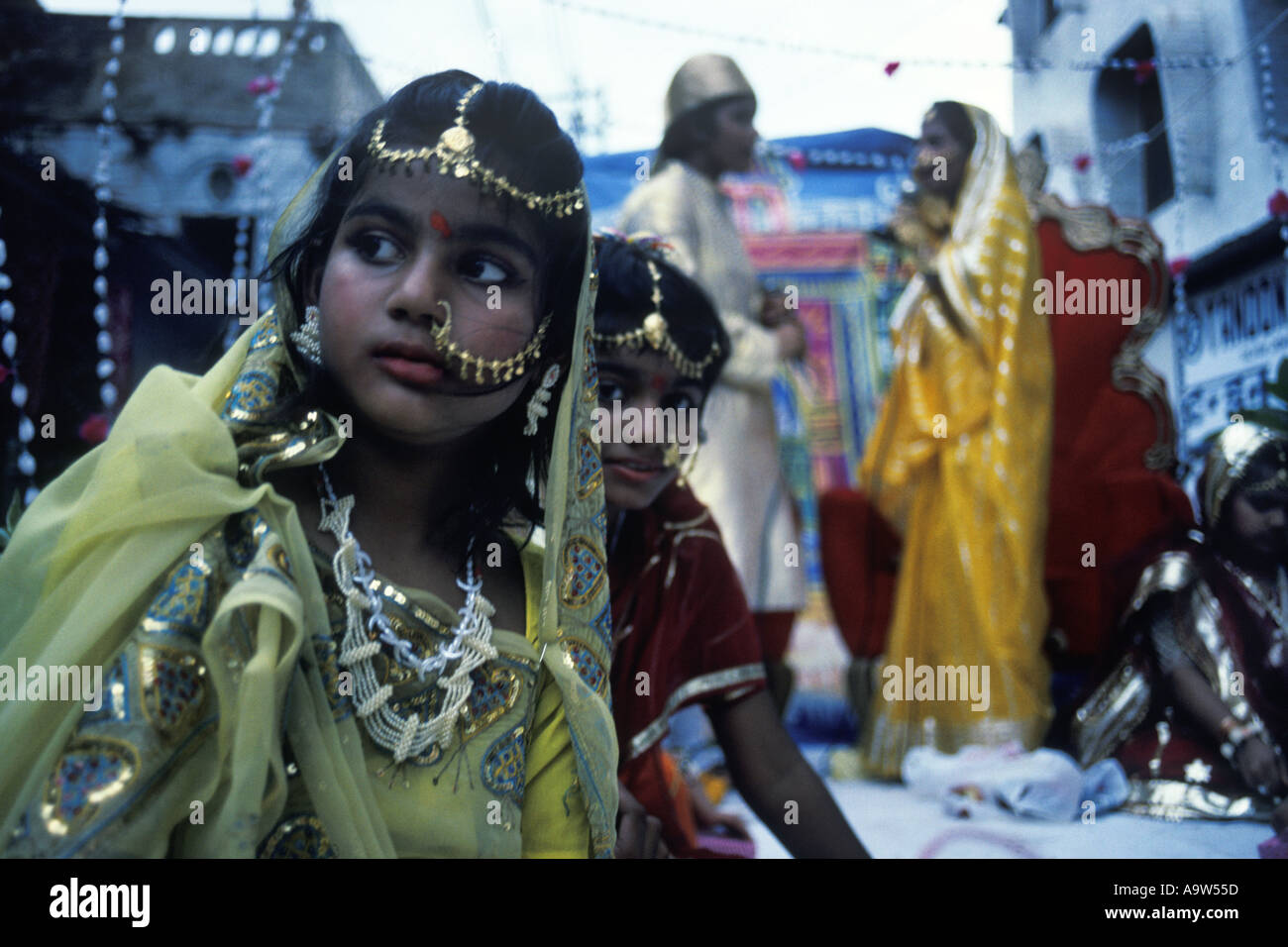 Girls sit on procession float during a street festival in Delhi India ...