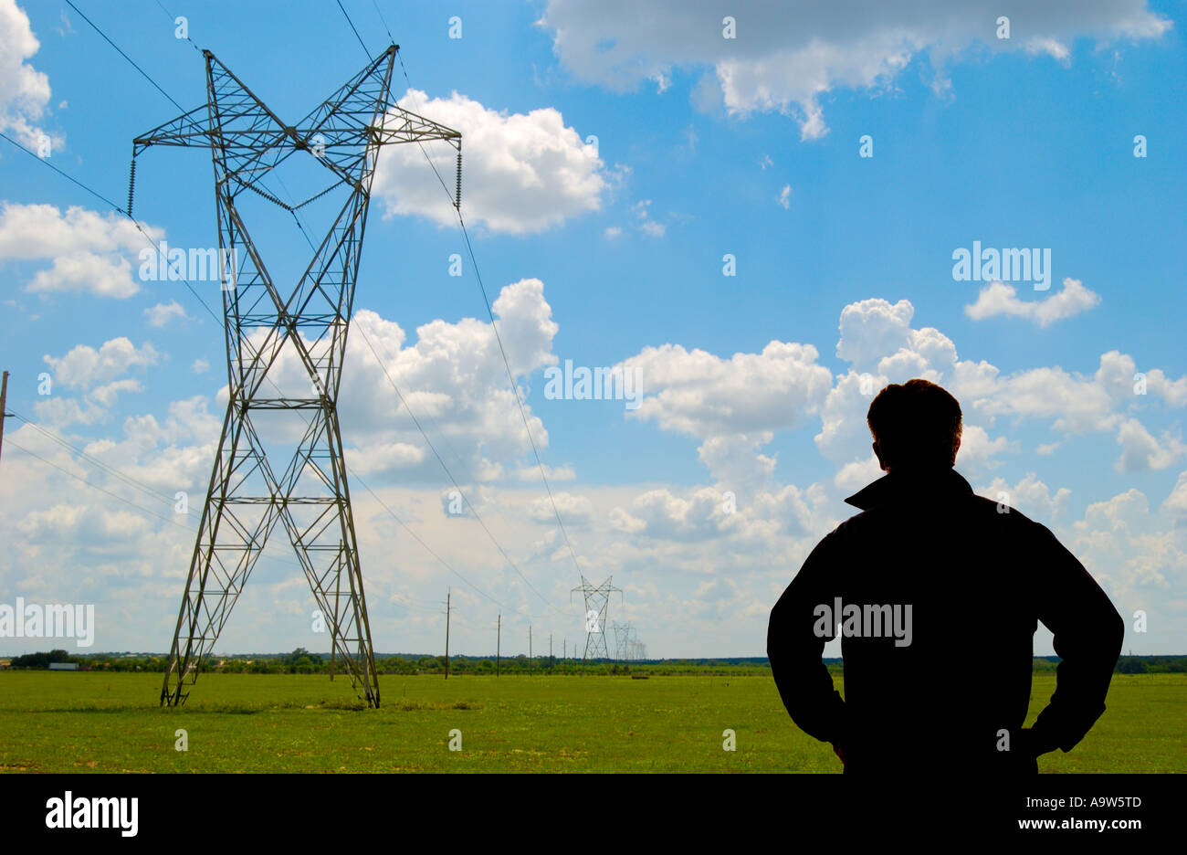 power manager checking on large power transmission lines and towers ...