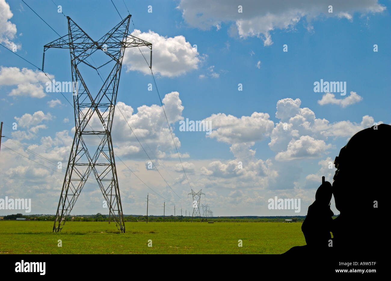 power manager checking large power transmission lines and towers on ...