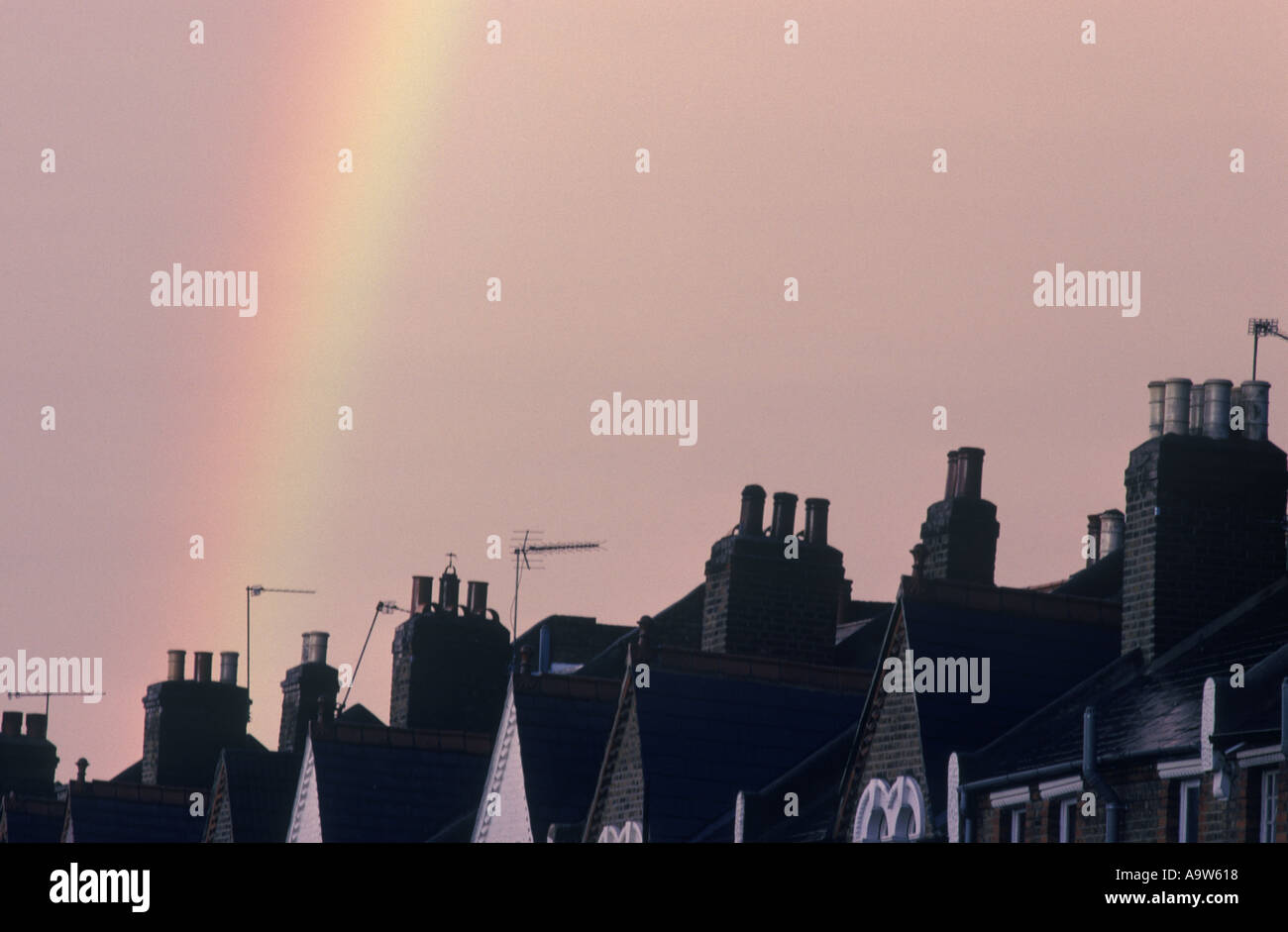Rainbow over houses in London Stock Photo - Alamy