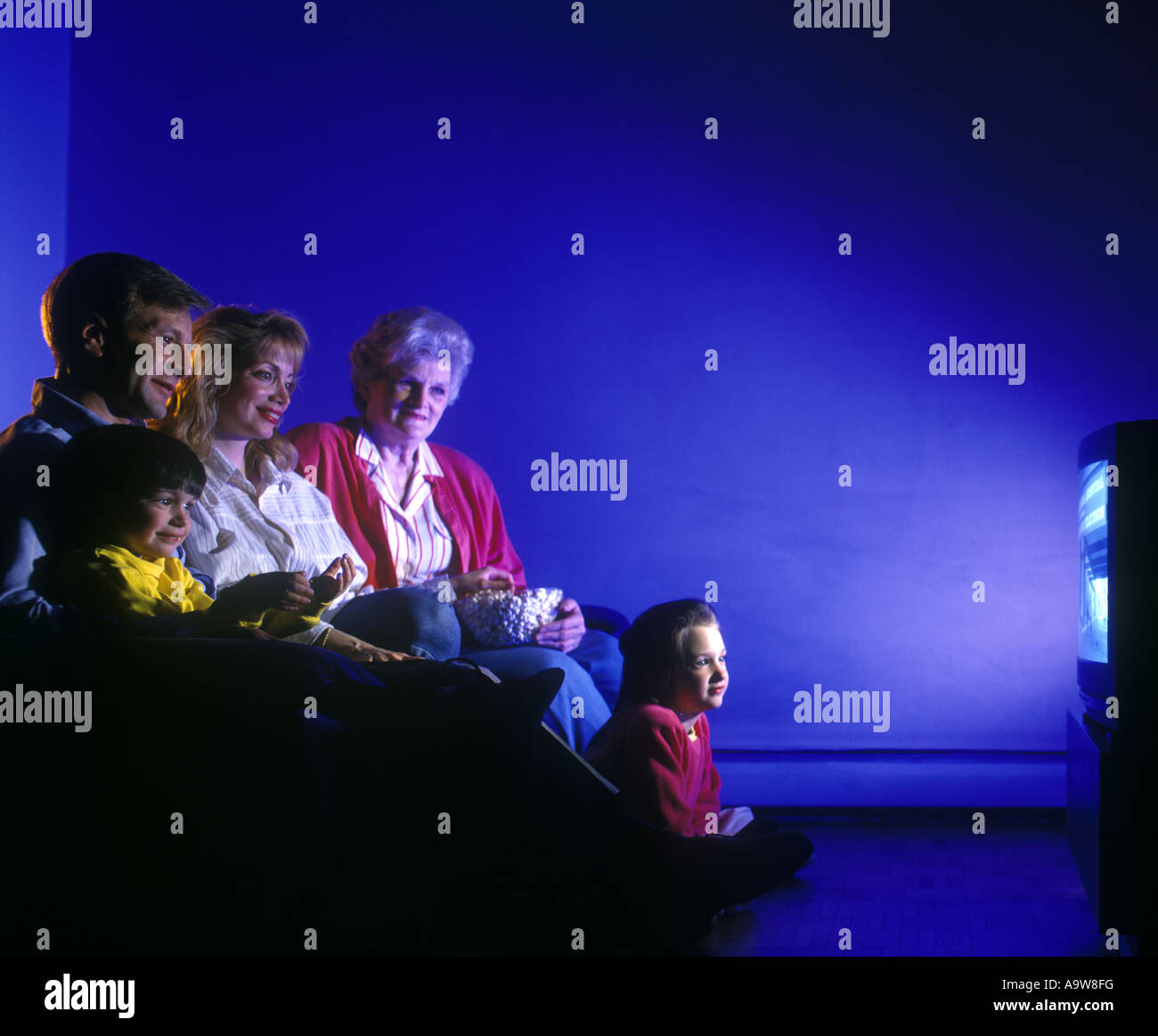 Three generations family watching tv hi-res stock photography and ...