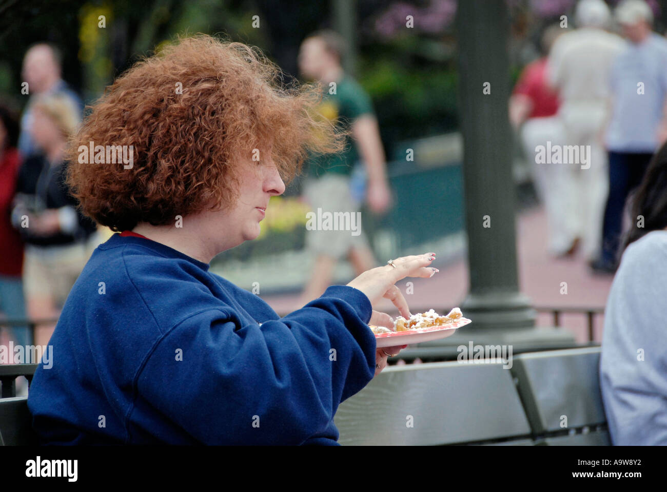 Adult female eating carnival food Stock Photo - Alamy