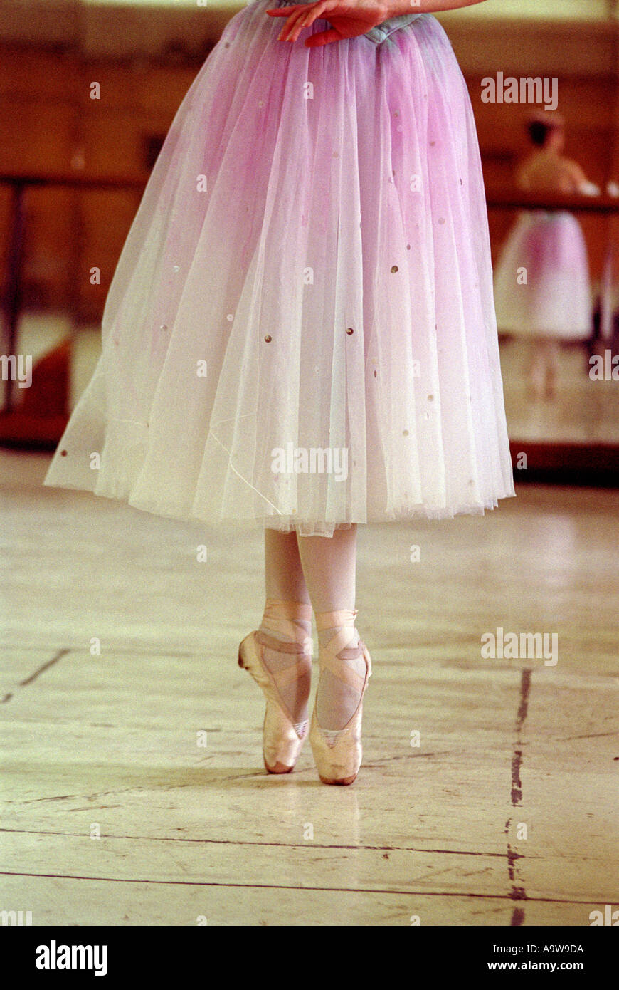 Female ballet dancer standing on her toes in toe shoes rehearsal ballet ...