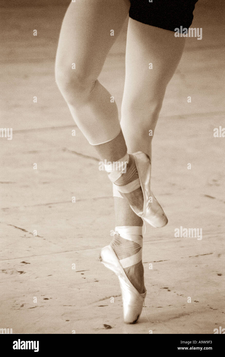 Female ballet dancer standing on her toes in toe shoes rehearsal ballet ...
