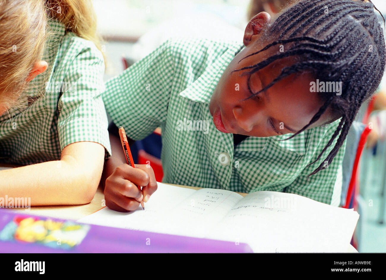 Two girls in classroom writing Johannesburg Gauteng South Africa Stock ...