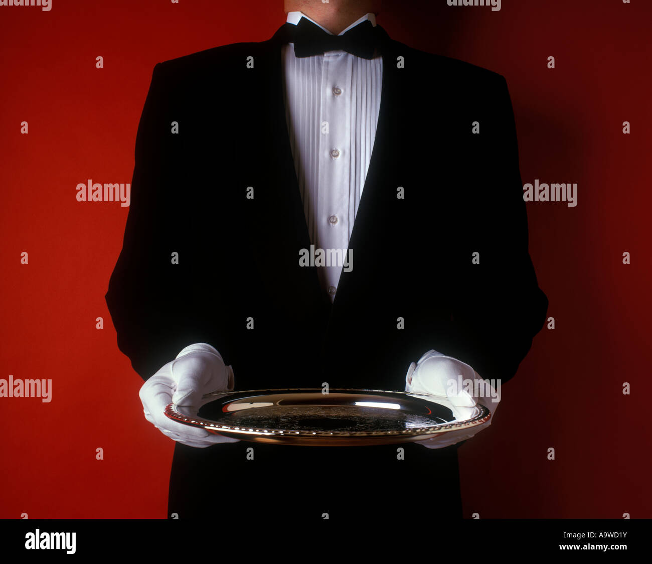 WAITER STANDING HOLDING SILVER PLATTER Stock Photo - Alamy