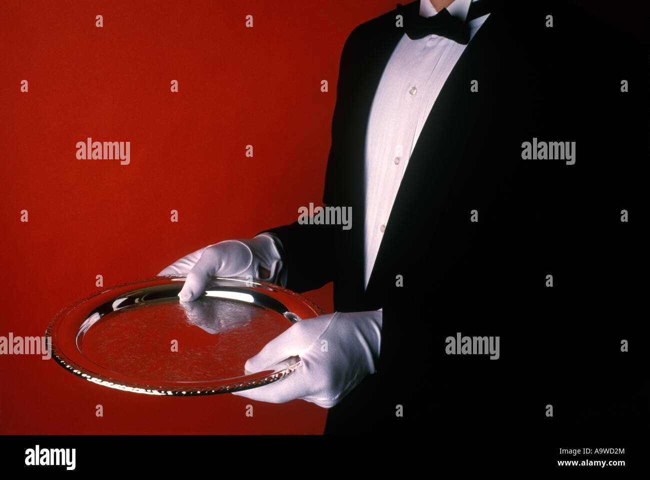 WAITER STANDING HOLDING SILVER PLATTER Stock Photo - Alamy