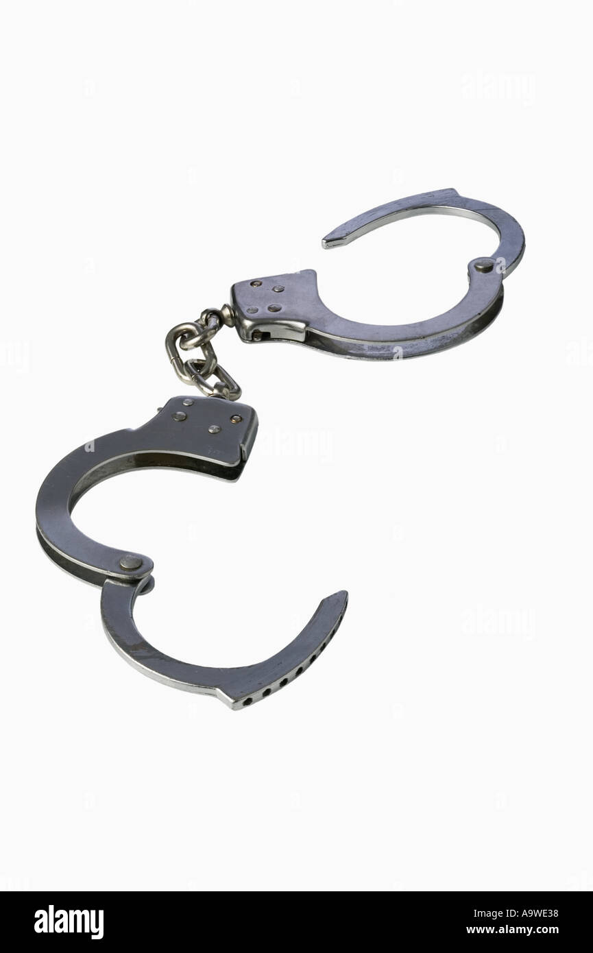 Open handcuffs silhouetted on white background Stock Photo - Alamy