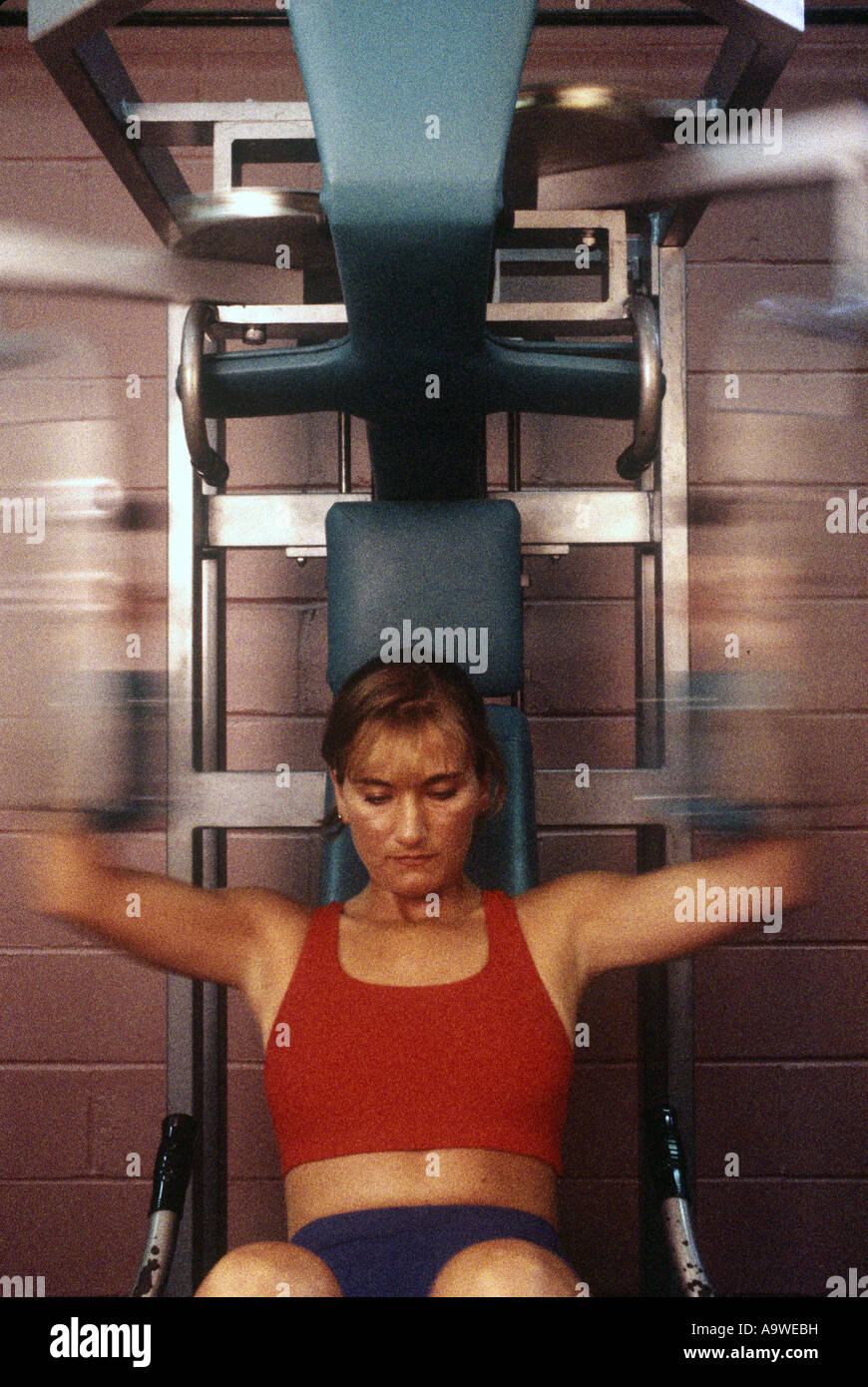 Woman using pectoral exercise hi-res stock photography and images - Alamy
