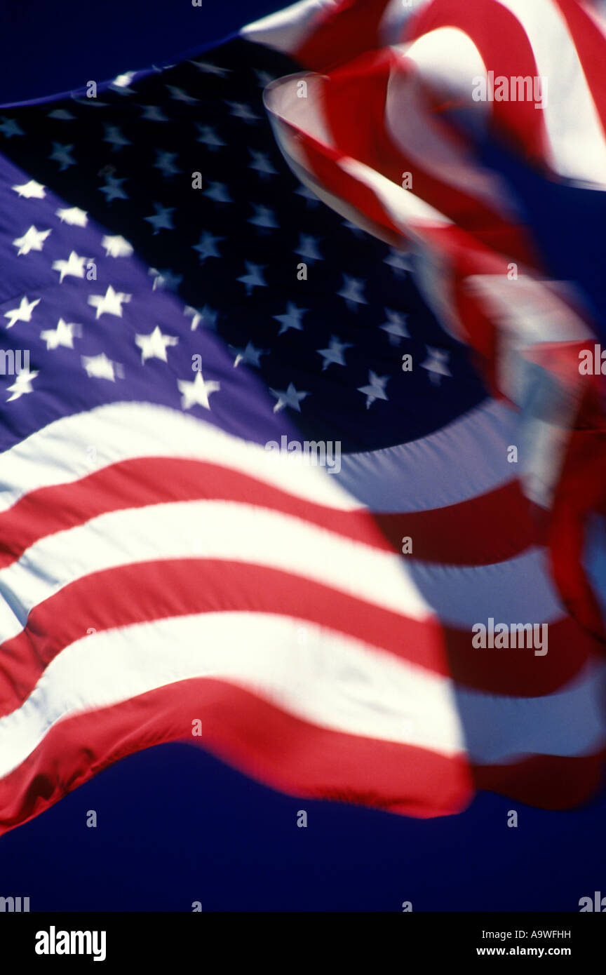 UNITED STATES FLAG FLYING ON FLAGPOLE WITH BLUE SKY Stock Photo - Alamy