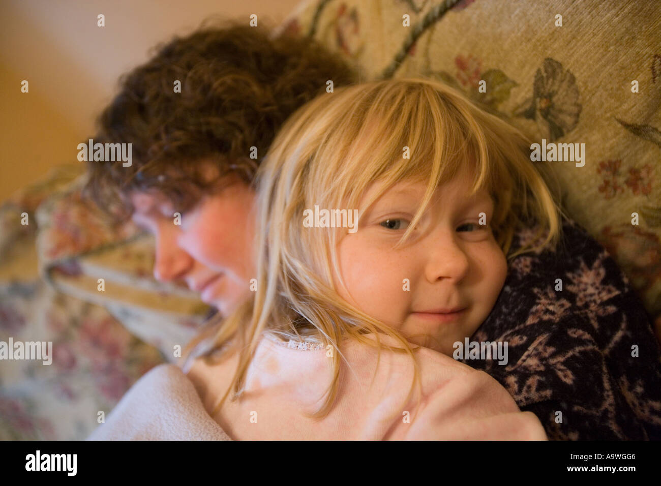 Mother and daughter having a loving cuddle together Stock Photo - Alamy
