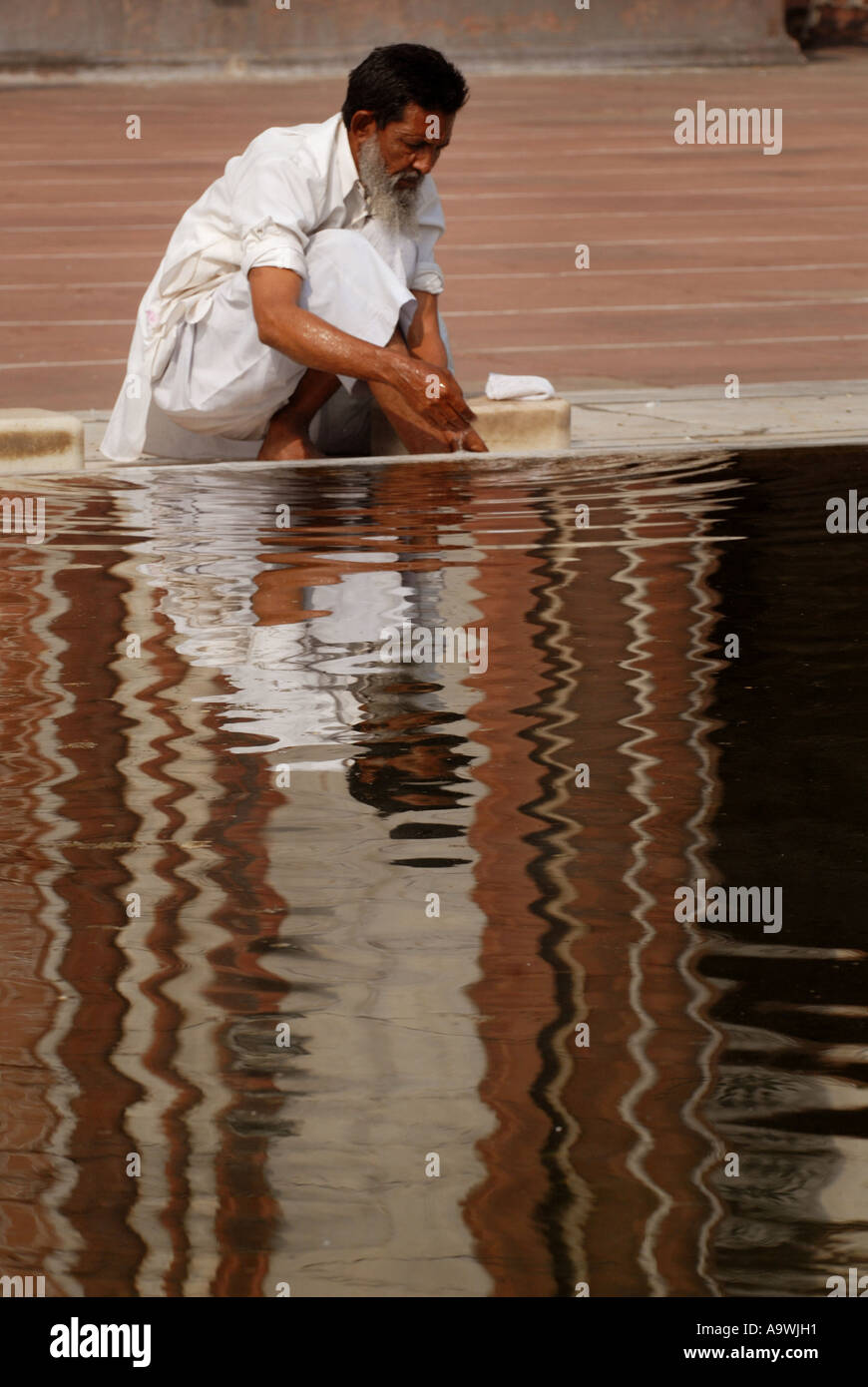 Man washing before prayers inside Jami Masjid The main mosque of Delhi ...