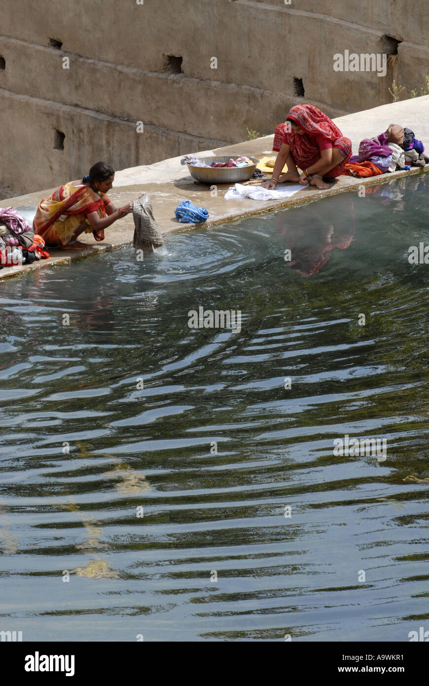 Indian girl washing clothes hi-res stock photography and images - Alamy
