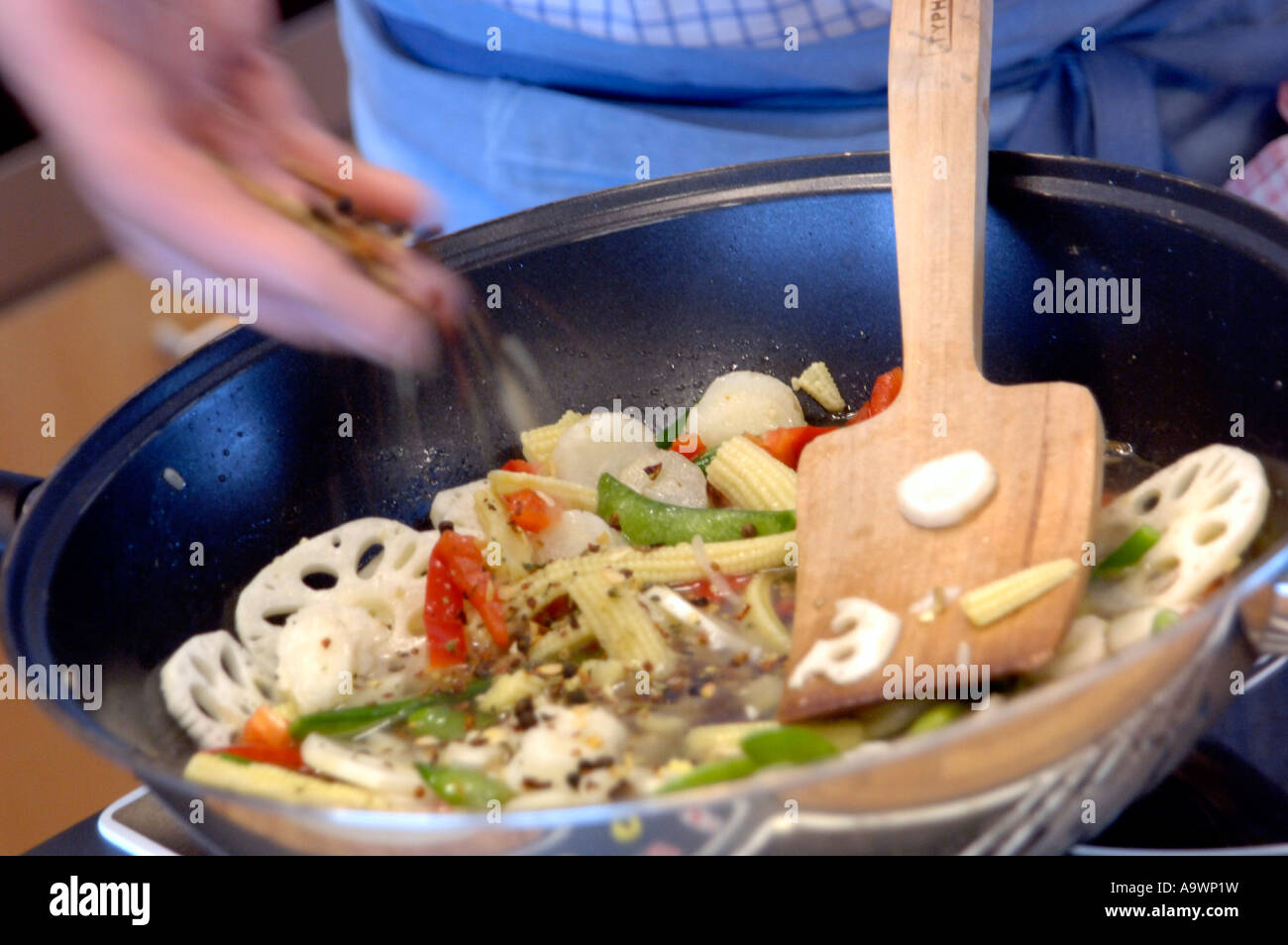 Stir frying vegetables in a wok Stock Photo - Alamy