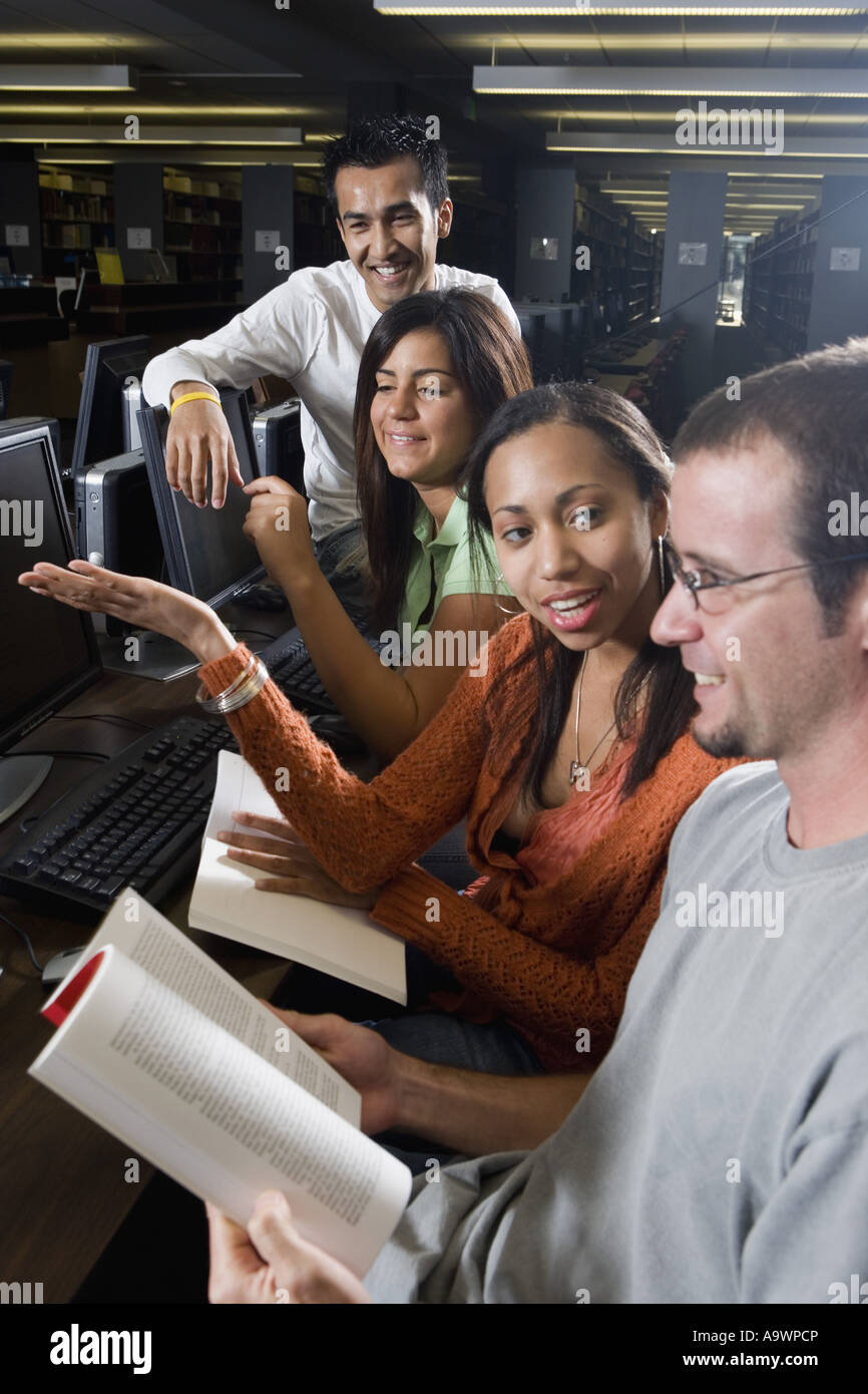 Young students using computers in the library Stock Photo - Alamy