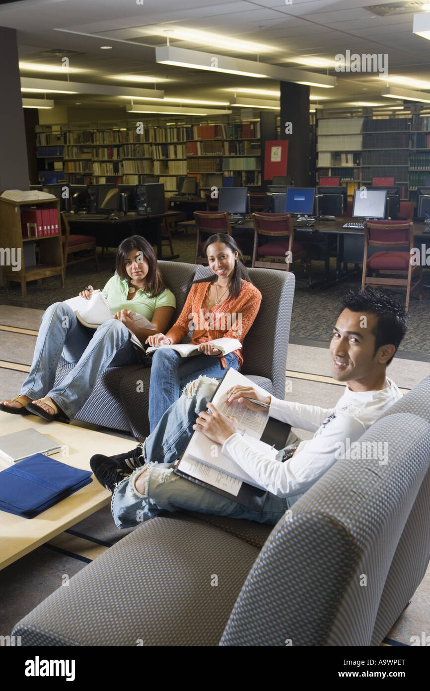 Students in library sitting on sofas studying Stock Photo - Alamy