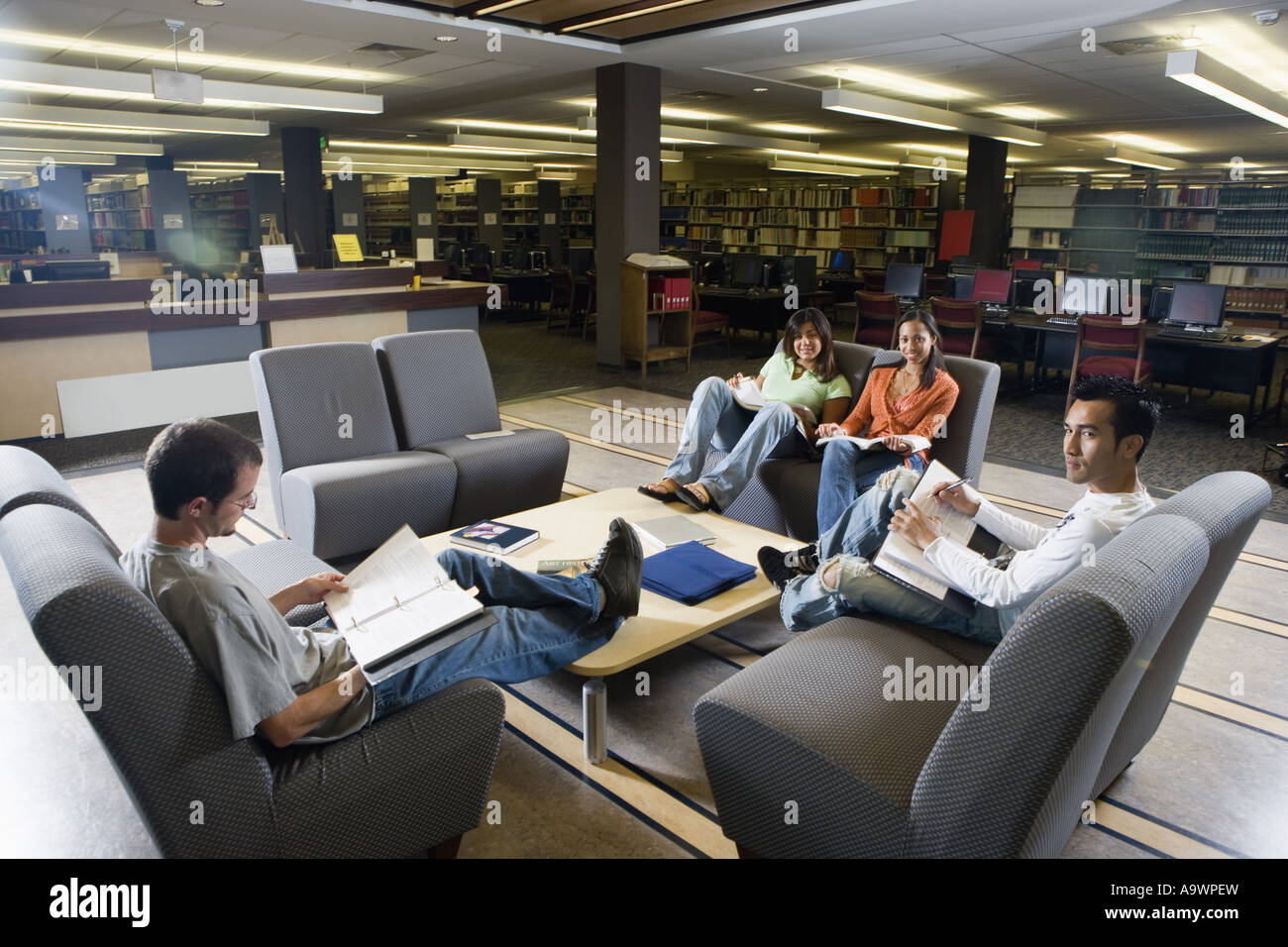 Students in library sitting on sofas studying Stock Photo - Alamy