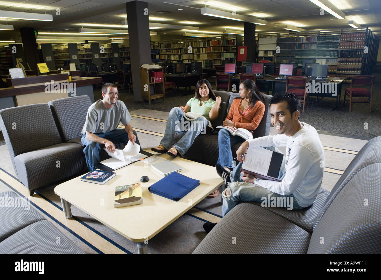 Students in library sitting on sofas studying Stock Photo - Alamy