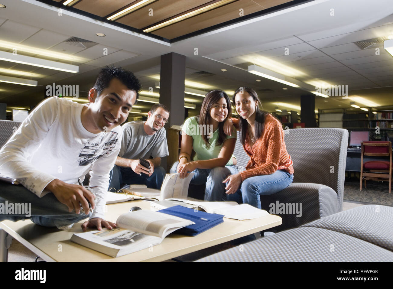 Students in library sitting on sofas studying Stock Photo - Alamy