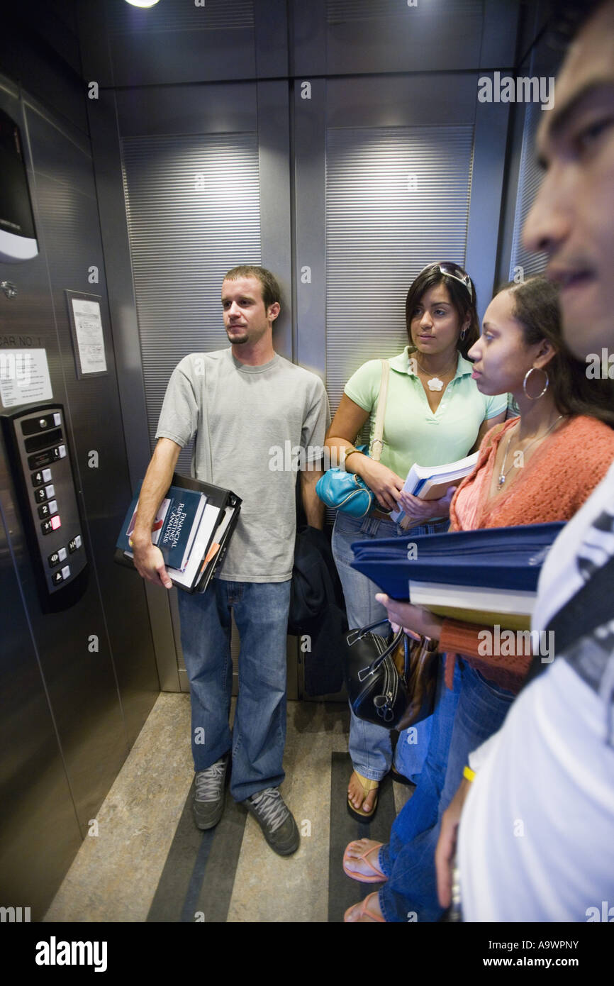 Students standing in an elevator Stock Photo - Alamy