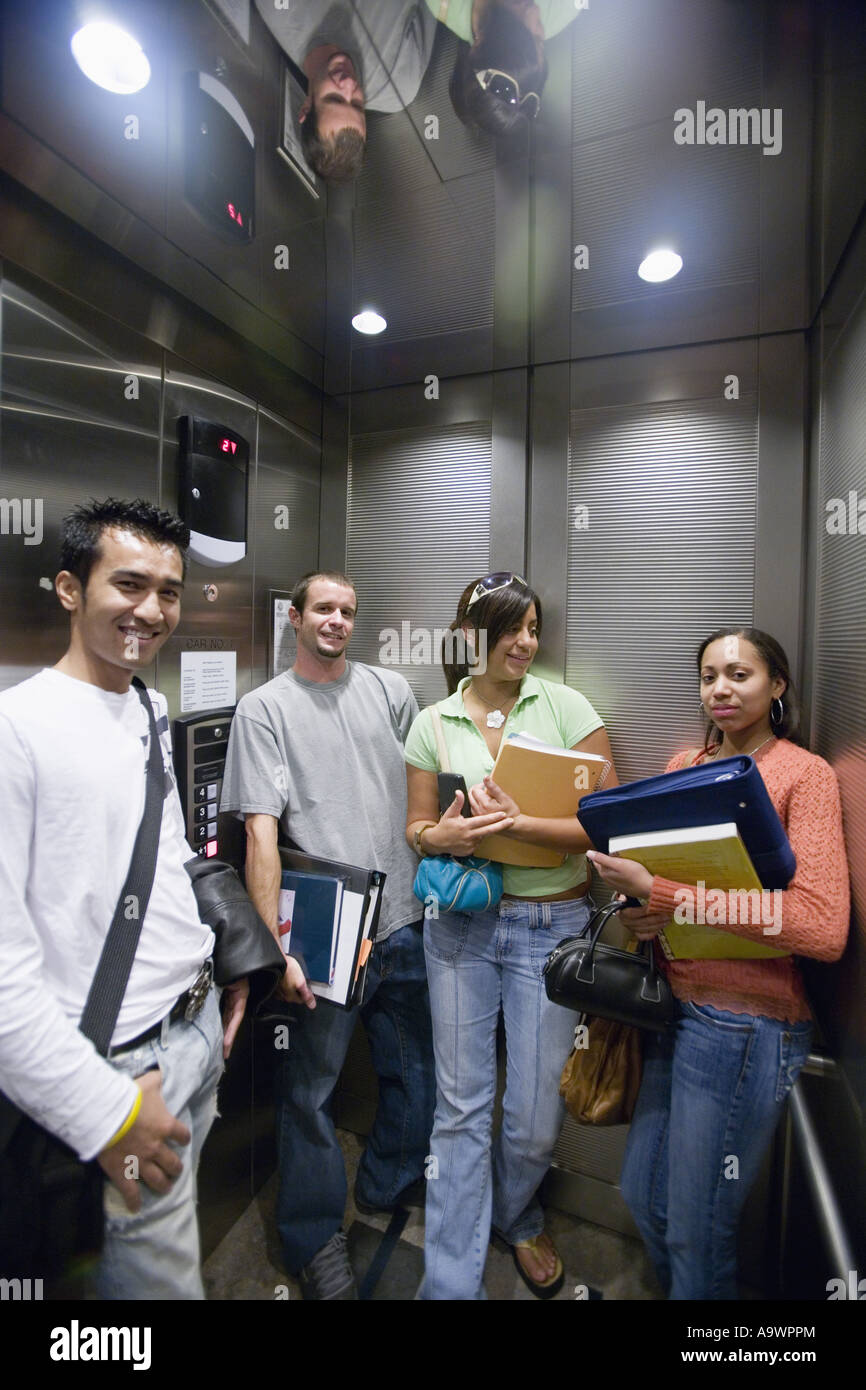 Students standing in an elevator Stock Photo - Alamy