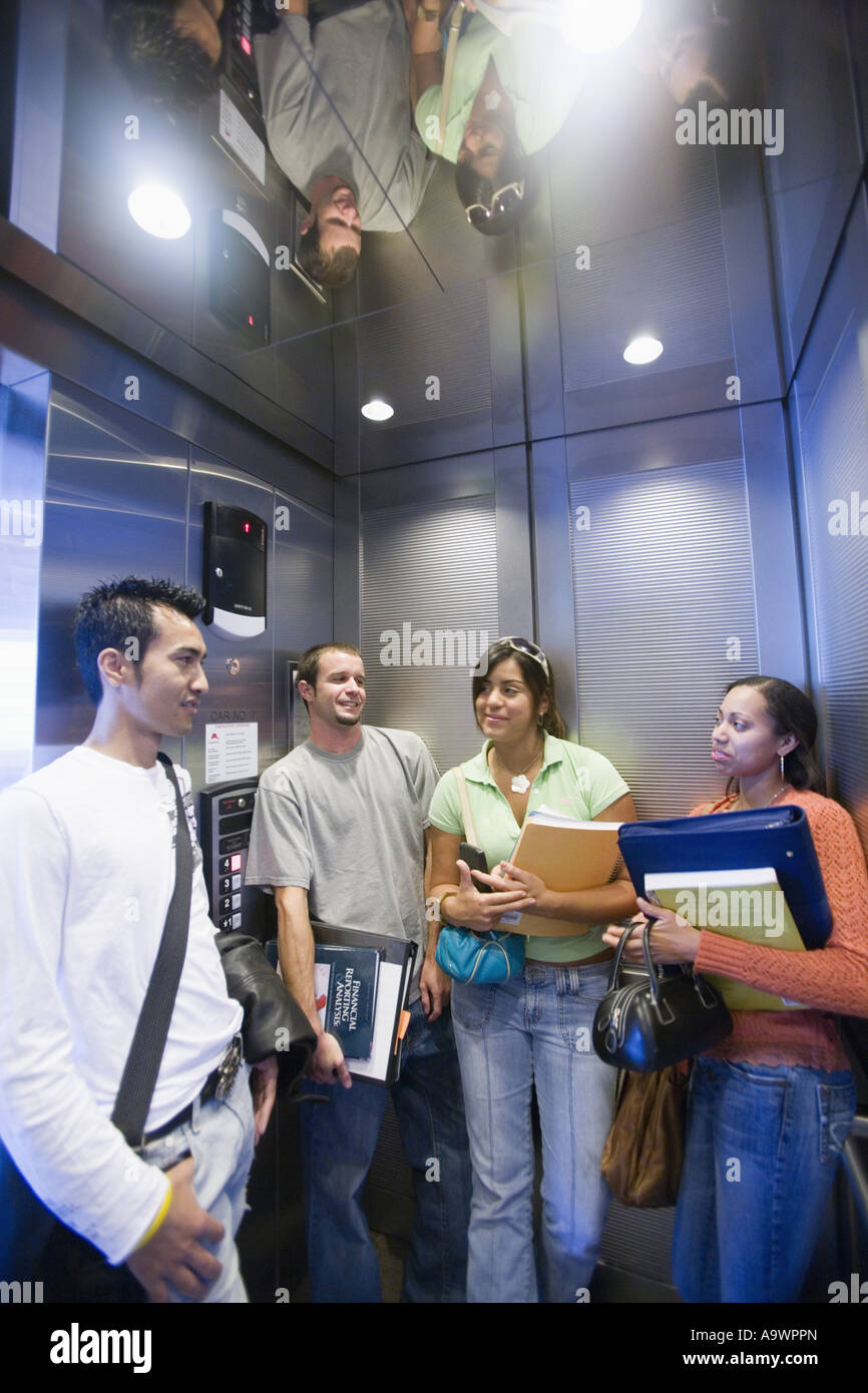 Students standing in an elevator Stock Photo - Alamy