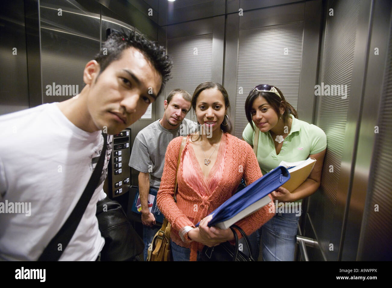College students looking out from elevator Stock Photo - Alamy