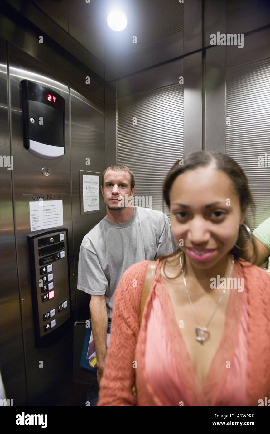 College students riding elevator Stock Photo - Alamy