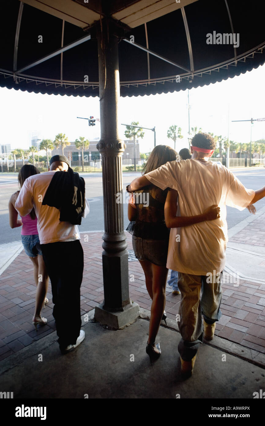 Young men and women leaving a bar at sunrise Stock Photo - Alamy